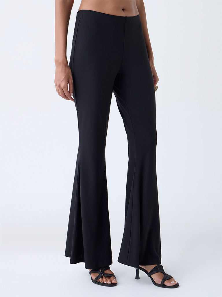 Buy Vark Black Flared Solid Pants from Westside